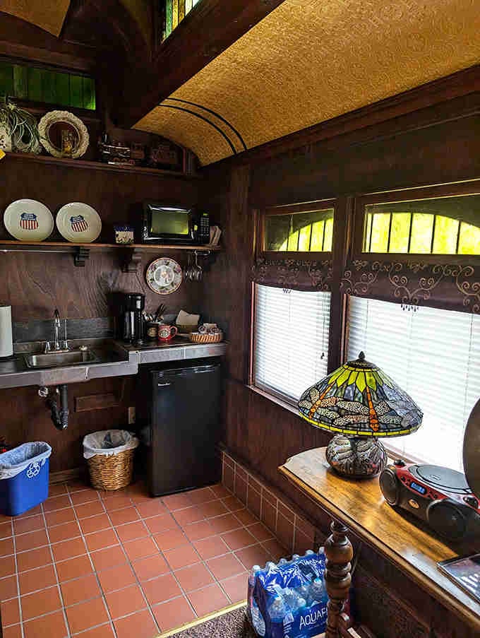 The kitchenette fits perfectly into the train car's compact space, making efficiency look downright charming and inviting.