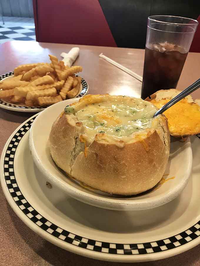 Bread bowl pot pie oozing with filling demonstrates that comfort food sometimes requires a spoon and serious commitment.