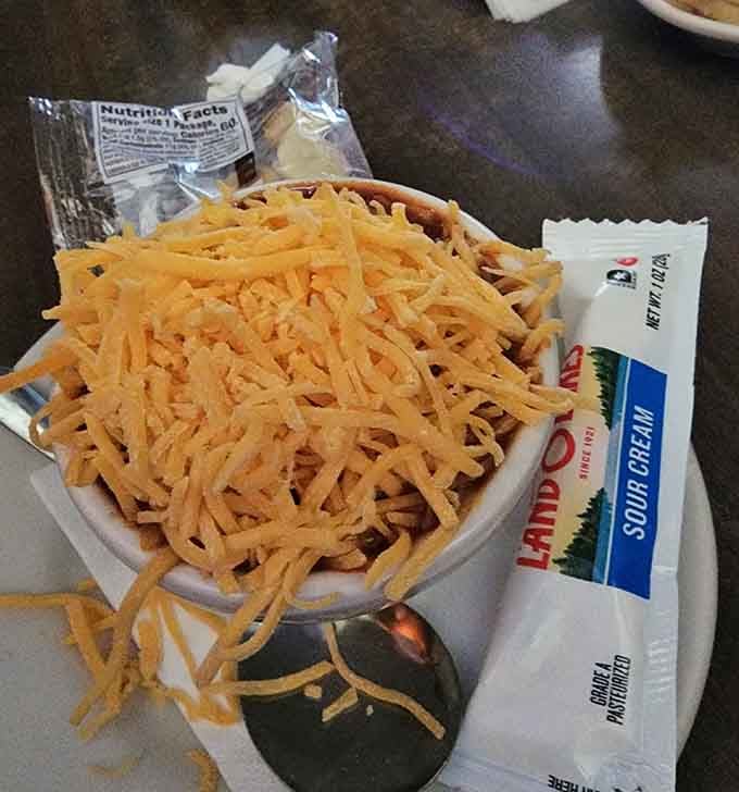 Chili cheese fries piled so high they defy gravity and all reasonable portion control expectations completely.