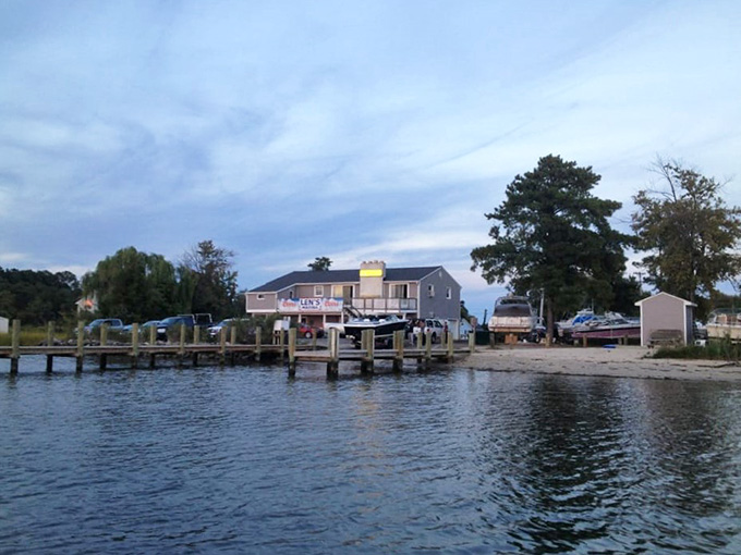 The long wooden dock stretches toward the marina building, inviting evening strolls and contemplation of life's simple pleasures.