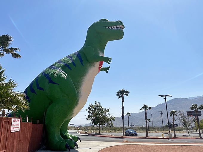This towering green T-Rex guards the desert like something escaped from Jurassic Park's gift shop on steroids.