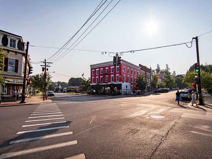 Morning light bathes the intersection where that handsome brick hotel has welcomed travelers since your grandparents were probably courting.