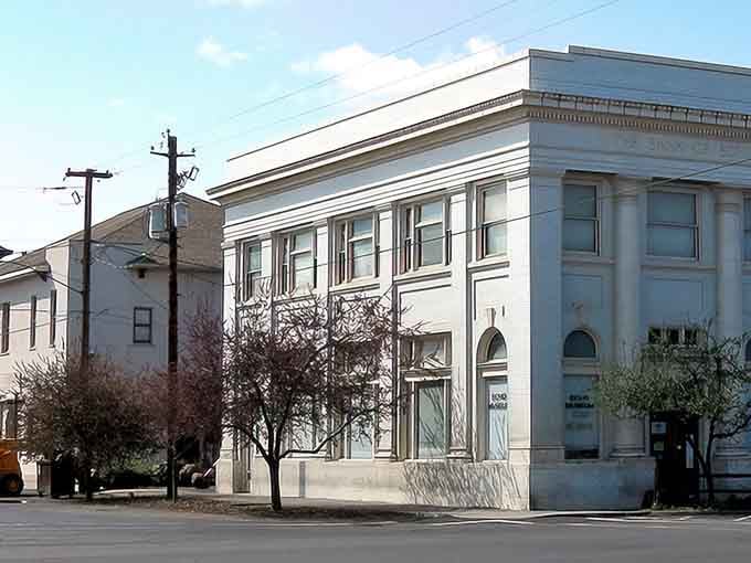 Classical columns paired with a white exterior reflect a time when buildings were designed with lasting dignity and care.
