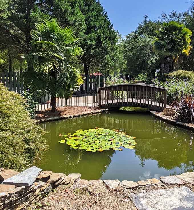 Lily pads float peacefully while a curved bridge connects two worlds, like something from a Monet painting gone three-dimensional.