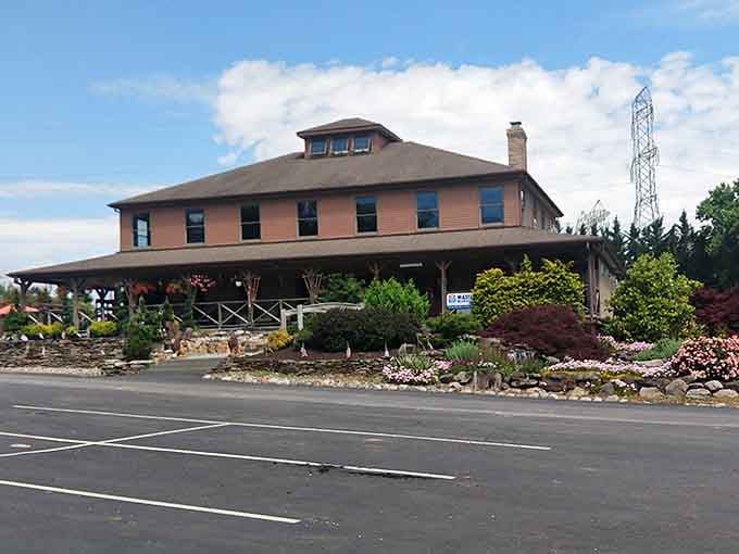 The substantial building anchors a hillside garden where rocks and flowers create natural-looking displays year-round for inspiration.