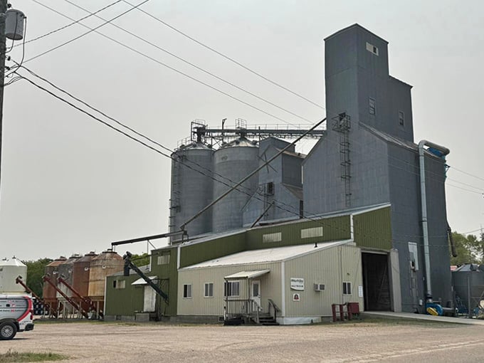 Gully's towering grain elevator complex commands the skyline with industrial authority — this is the honest, hardworking heartbeat of the northwest.