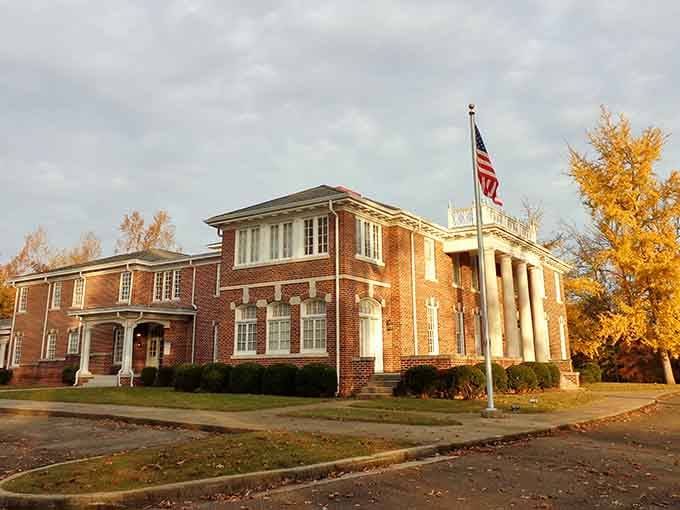 Golden autumn light bathes this handsome brick building where classical columns suggest importance and permanence in equal measure.