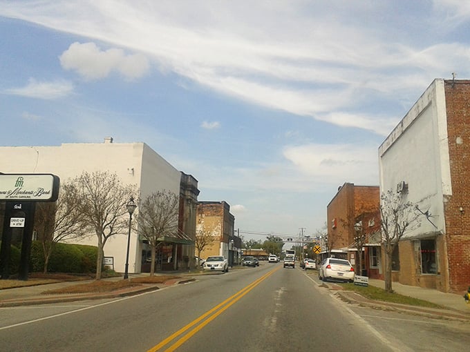 Main Street stretches toward the horizon with brick buildings standing shoulder to shoulder like old friends catching up.