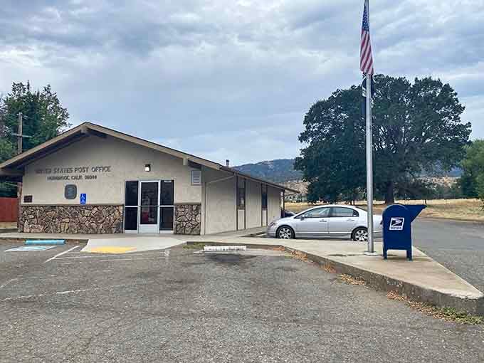 Even the post office looks peaceful here, standing beneath the flag where mail delivery still feels personal and unhurried.