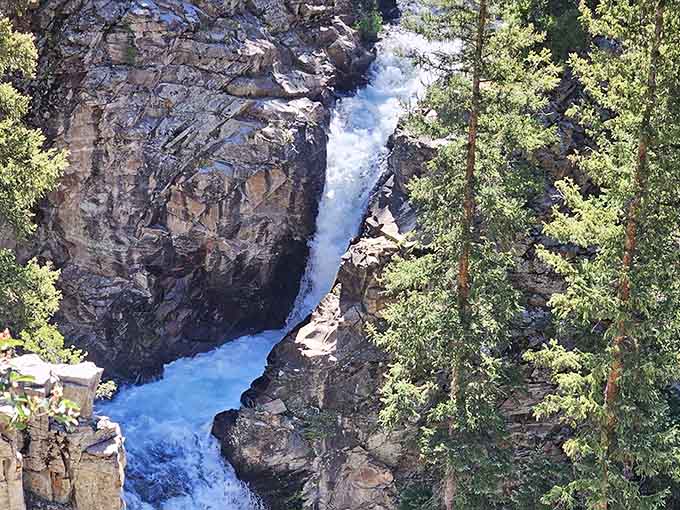 The rocky channel guides water downward in stages, each level adding its own character to the journey.
