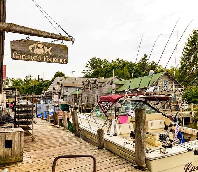 The wooden boardwalk stretches past rustic shanties where real fishermen still bring in their daily catch from the lake.