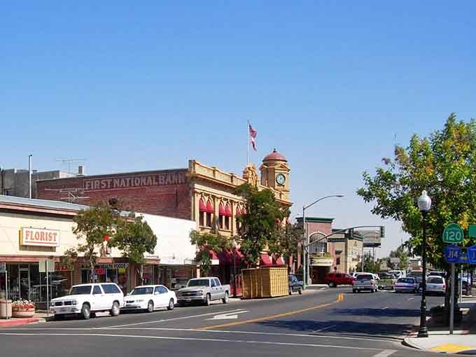 The ornate bank building with its clock tower stands as a testament to when small towns built landmarks to last.