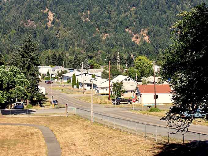 Forest-covered mountains embrace this tiny community like a green hug that never lets go, even in summer heat.