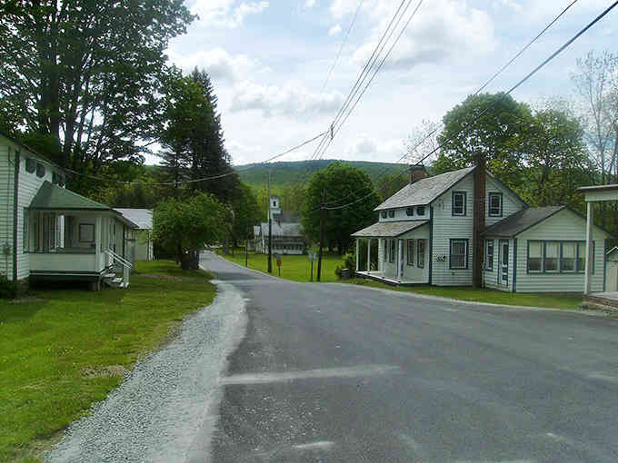 Mountain backdrop cradles this peaceful hamlet where the biggest rush is deciding which porch rocker to claim.