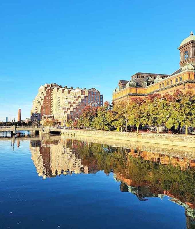Fall colors frame the waterfront where historic buildings stand proud, their reflections doubling the beauty you see.