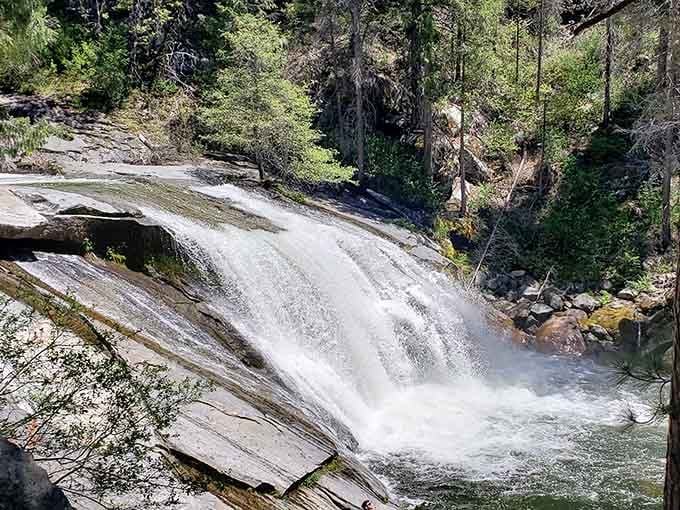Water sheets down smooth granite in a display that proves the Sierra knows how to put on a show.