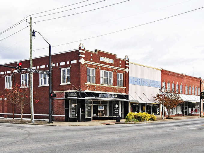 Historic storefronts stand shoulder to shoulder, their weathered brick faces telling stories of commerce through the decades.