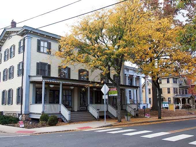 Classic colonial architecture with black shutters houses restaurants where tradition meets innovation on every single plate served.