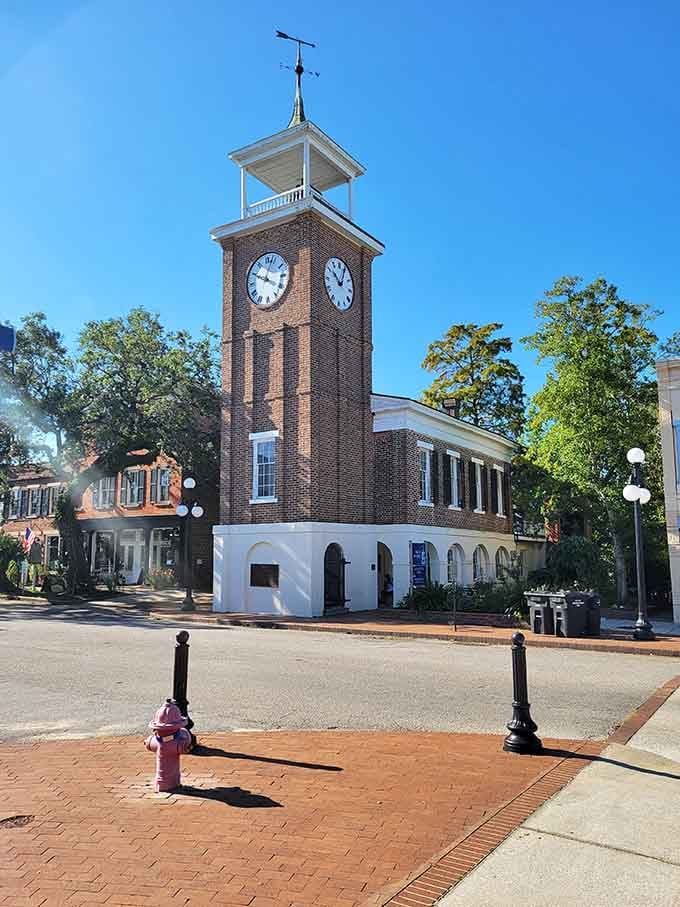 That brick clock tower anchors the town square like it's been keeping time since George Washington's day.