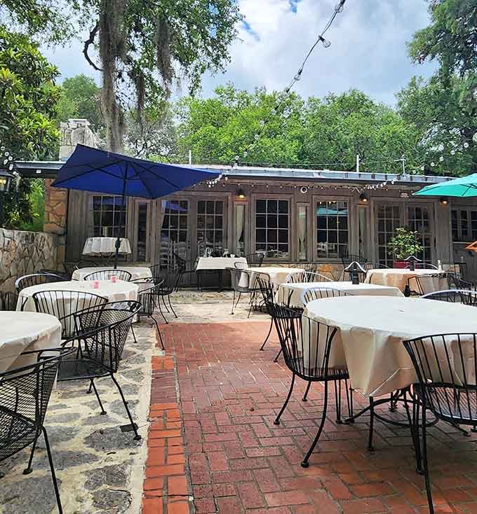 Blue skies and colorful umbrellas frame this charming courtyard where great food meets even better atmosphere every time.