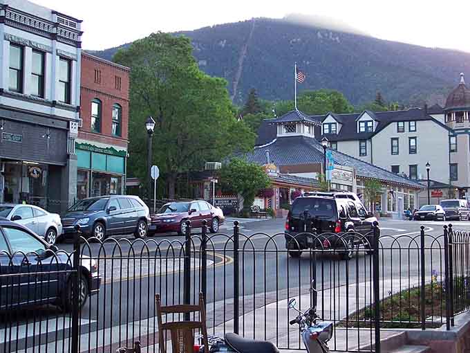Mountain shadows fall across downtown as evening approaches and locals gather where historic architecture meets modern mountain living.