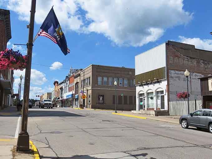 Hanging flower baskets and proud flags show a community that still believes main streets matter more than malls.