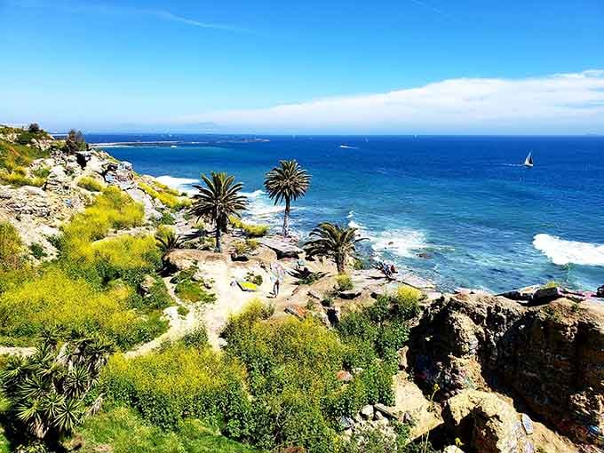 Palm trees and ocean views frame crumbling foundations, nature reclaiming what the cliffs couldn't hold onto forever.