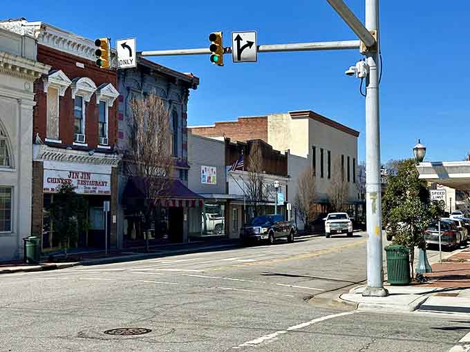 Classic storefronts line streets where traffic lights still feel optional and neighbors wave from passing cars.