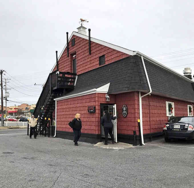 The weathered exterior tells stories of countless meals served, while that staircase promises elevated dining in every sense.