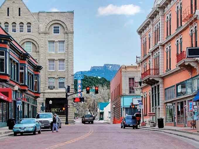 Mountains frame the end of Commercial Street like nature's own postcard reminding you why Colorado living beats anywhere else.