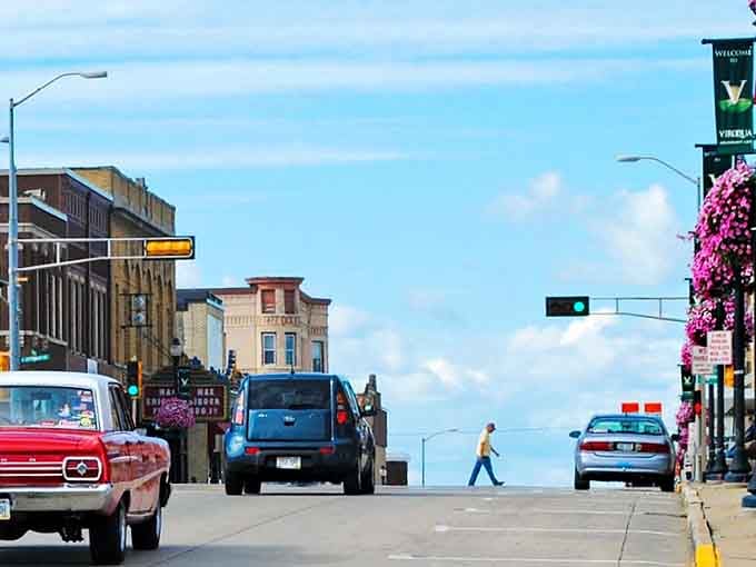 The street slopes toward endless sky, where hanging flower baskets add splashes of pink to Viroqua's charming downtown.