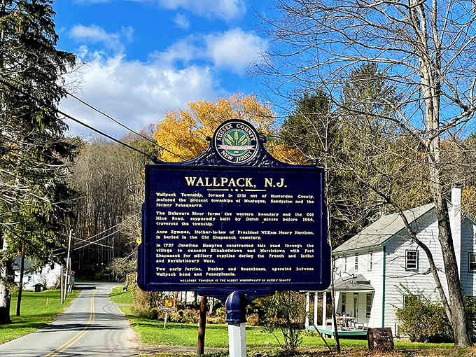 The historical marker tells tales of a vanished community, now preserved in wilderness where nature reclaimed its throne.