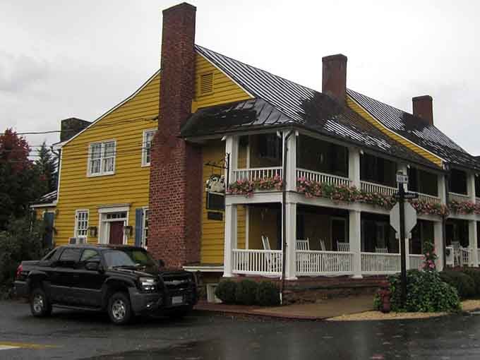 That cheerful yellow facade with double porches practically begs you to sit awhile with sweet tea in hand.