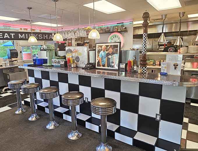 Chrome counter stools with black and white checkerboard tiles below create the perfect perch for solo diners and people watchers.