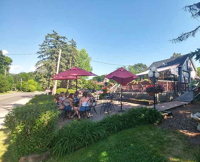 Families gathering under burgundy umbrellas, proving that the best conversations happen when everyone's holding something cold, sweet, and absolutely delicious.