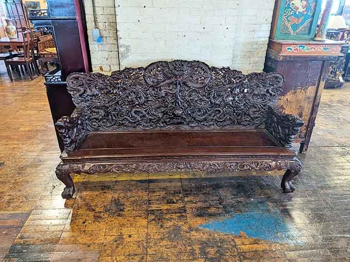 This intricately carved bench looks like dragons had a really productive afternoon in someone's woodworking shop.