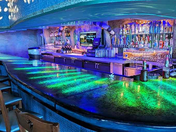 A bar top that glows like the ocean floor makes every cocktail feel like a deep-sea discovery.