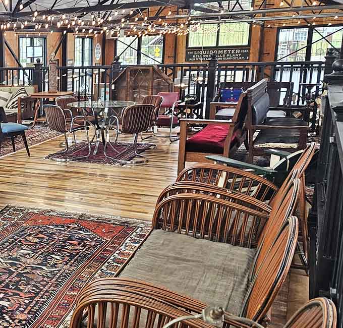 Vintage seating arrangements create an impromptu living room, proving that furniture shopping here feels more like visiting than browsing.