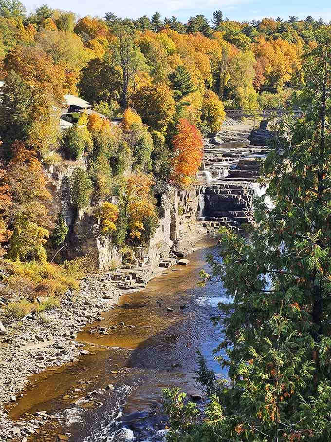 Autumn transforms the surrounding forest into a painter's palette, contrasting brilliantly against timeless gray sandstone.