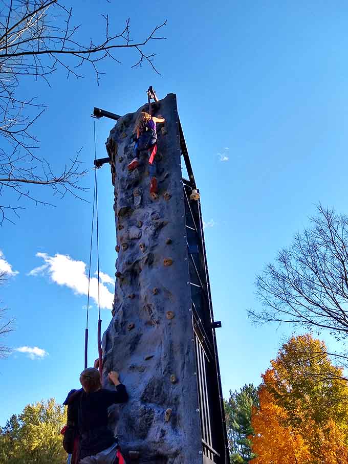 The climbing wall challenges brave souls to defy gravity while the rest of us watch safely from below.