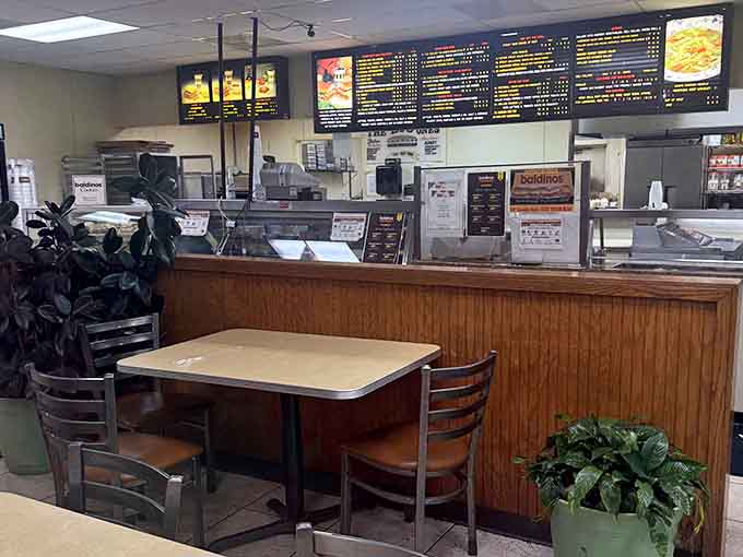 The ordering counter where dreams are built, one perfectly sliced layer of meat and cheese at a time.