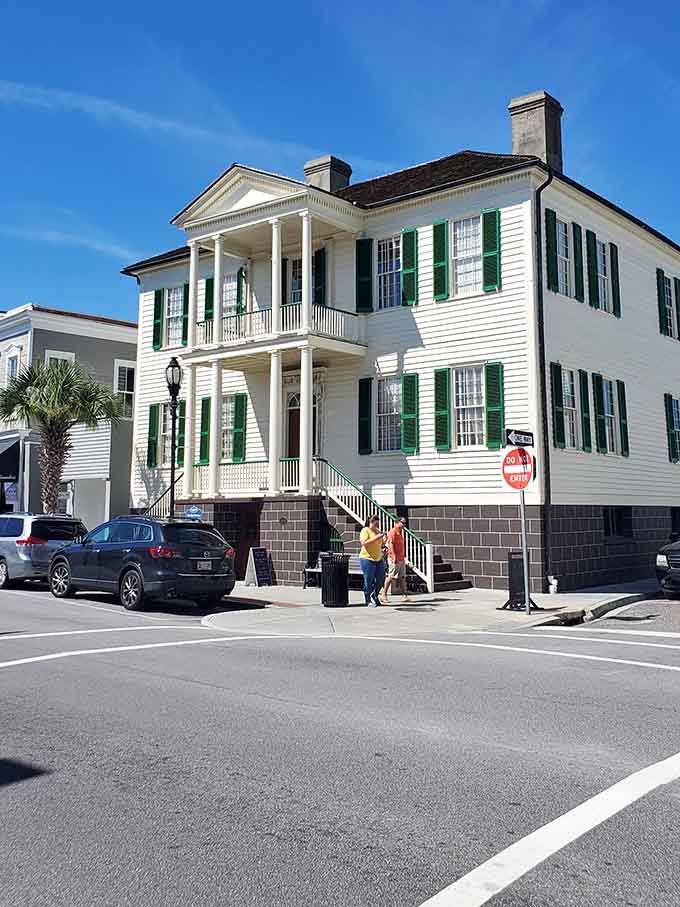 Green shutters pop against pristine white clapboard, proving that classic Southern architecture never goes out of style here.