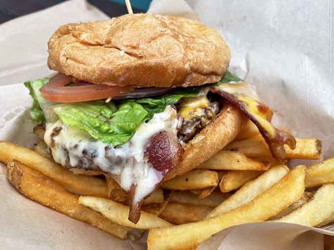 That bacon-topped burger sits like a delicious tower of indulgence, proving Bennett's doesn't discriminate against landlubbers seeking satisfaction.