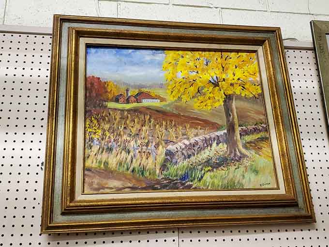 Original artwork in ornate frames transforms blank walls into gallery spaces without the gallery price tags attached to them.
