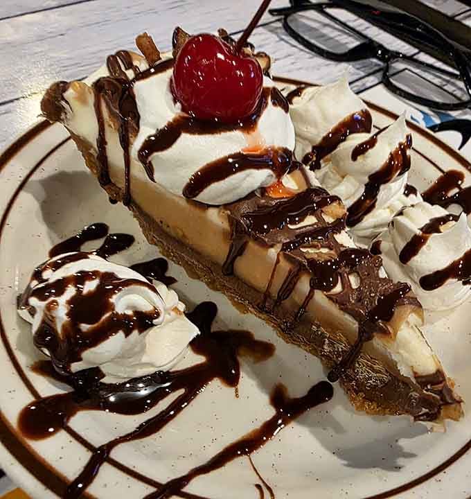 Dessert arrives drizzled with chocolate and topped with whipped cream, because you definitely saved room for this masterpiece.