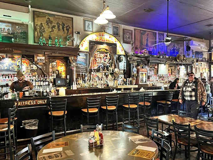 Stained glass art depicting Wild West legends glows above diners enjoying their meals in this atmospheric historic space.