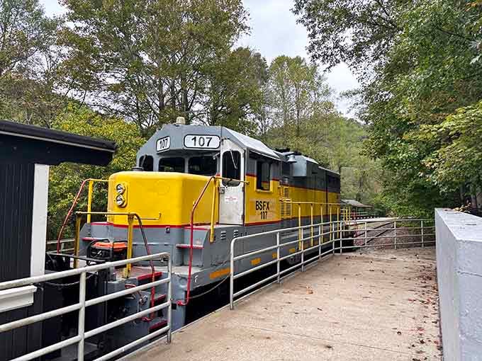 The yellow and white locomotive waits on the turntable, ready to pivot and head back up the mountain with fresh passengers.