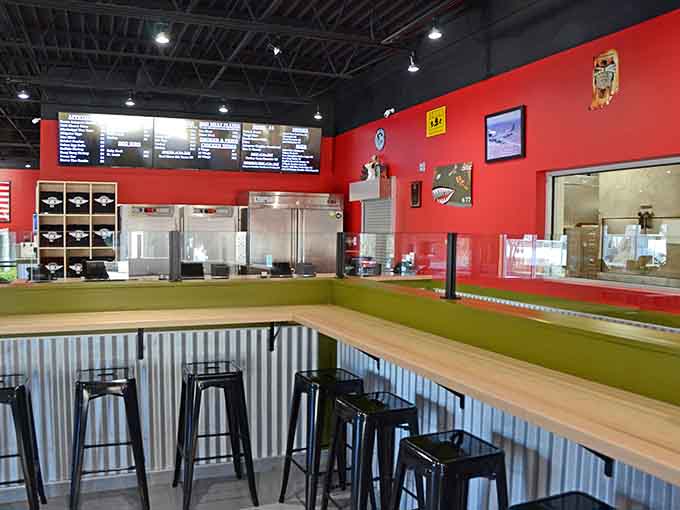Counter seating with a front-row view of where all the magic happens behind that bright red wall.