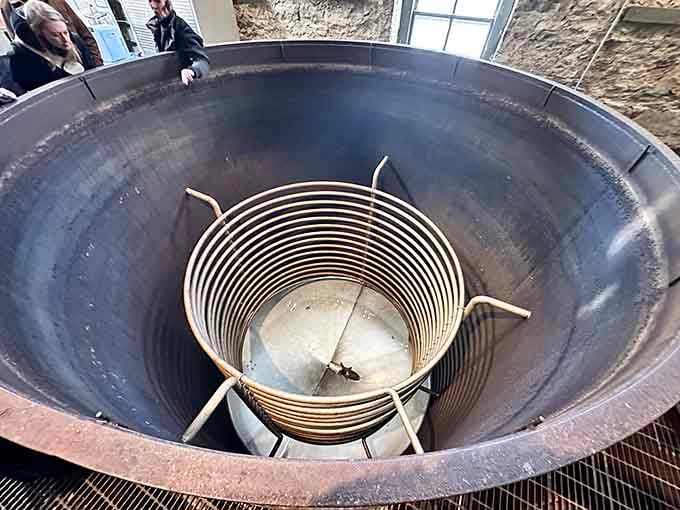 Inside the mash tun, grains begin their transformation into liquid gold through heat, water, and distilling wizardry beyond understanding.