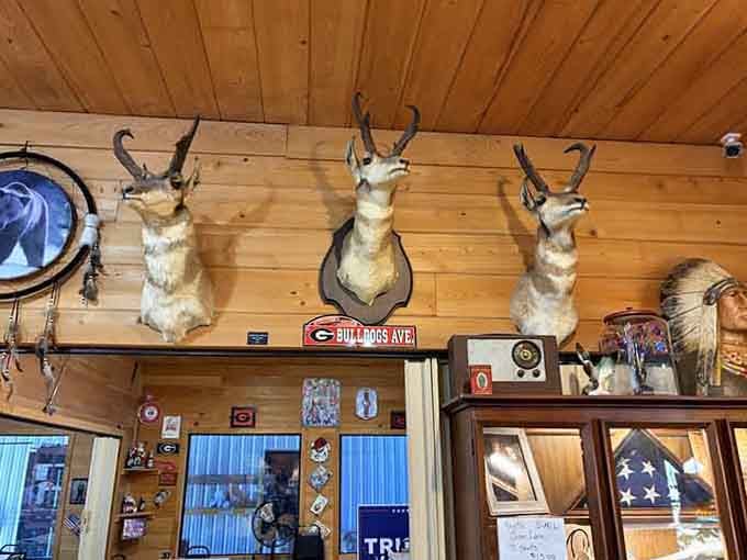 Antelope mounts and Georgia Bulldogs memorabilia create authentic hunting lodge vibes throughout the dining room.